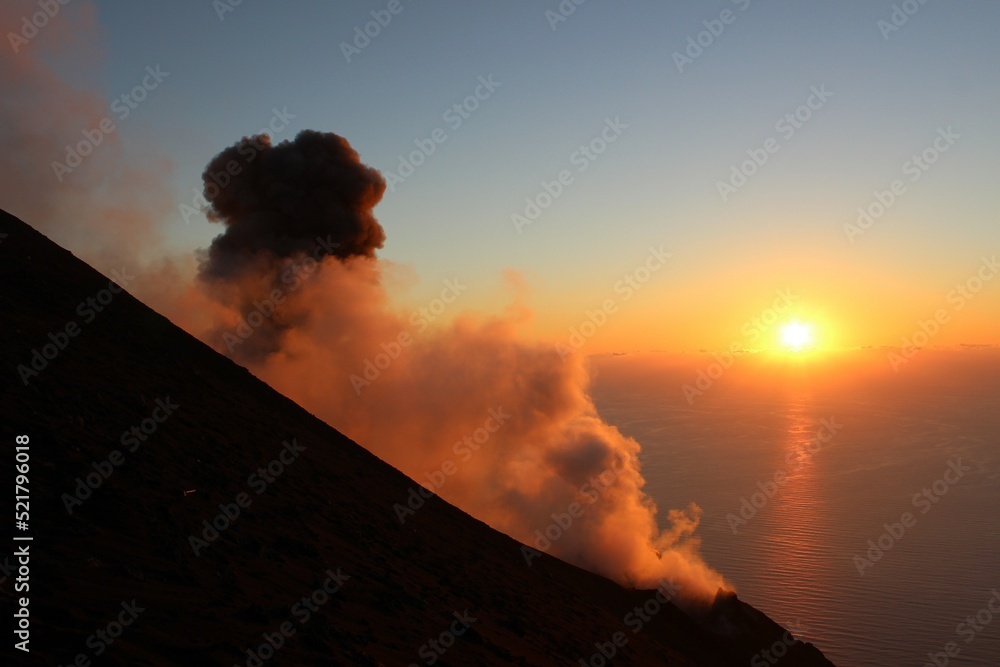 Sunset over the Stromboli volcano in Italy. Volcanic eruption, clouds ...