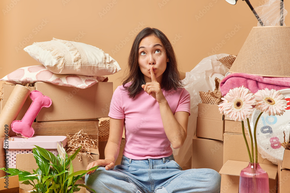 Asian woman makes silence gesture shares secret looks above dressed in ...