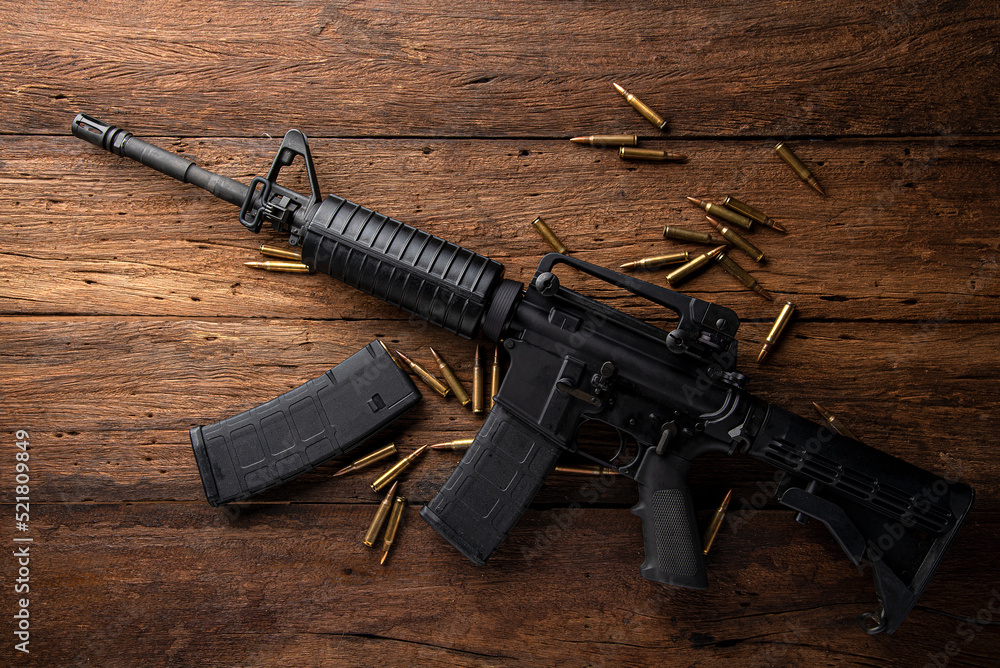 Gun with ammunition on background. Stock Photo | Adobe Stock