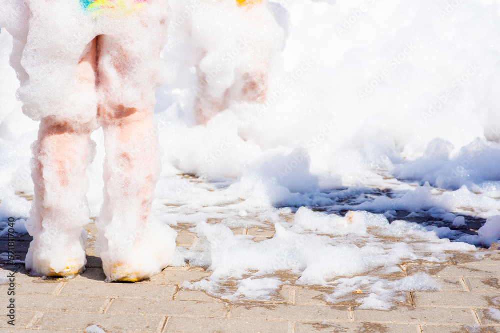 child's feet in foam at a foam party or celebration on a hot summer day ...