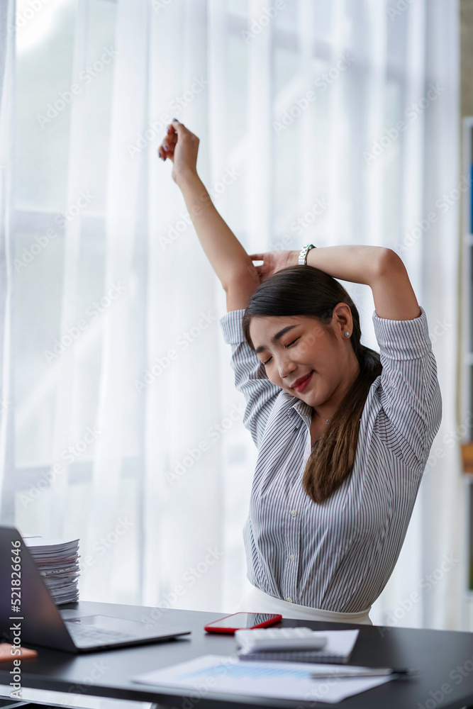 Attractive Asian business woman Relax from work after sitting for a ...