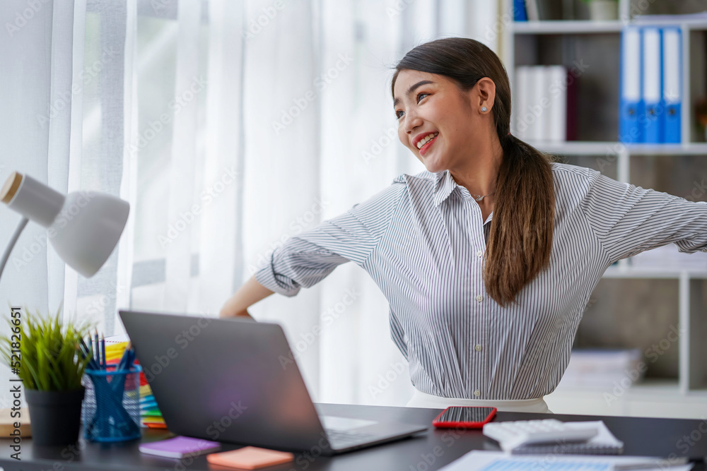 Attractive Asian business woman Relax from work after sitting for a ...