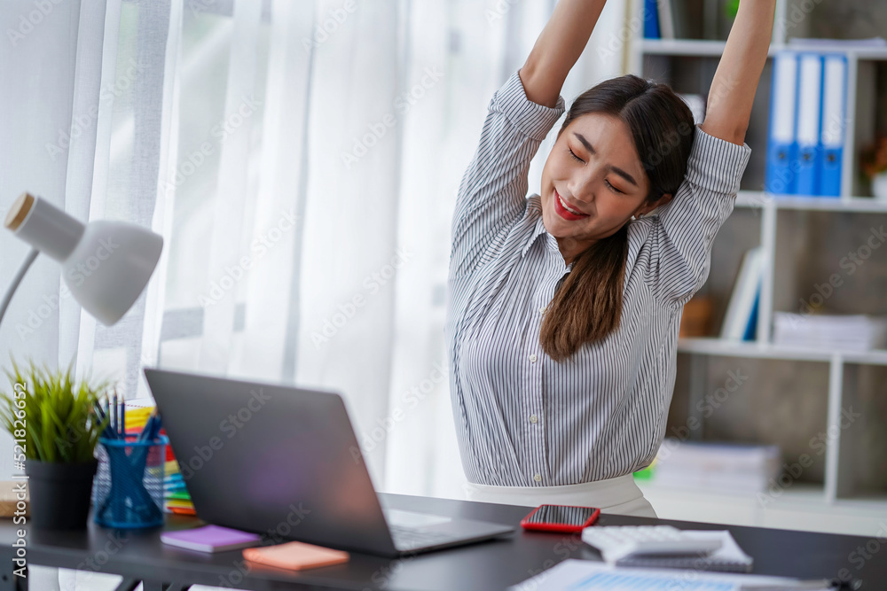 Attractive Asian business woman Relax from work after sitting for a ...