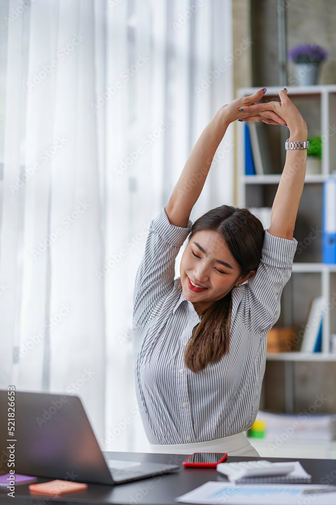 Attractive Asian business woman Relax from work after sitting for a ...
