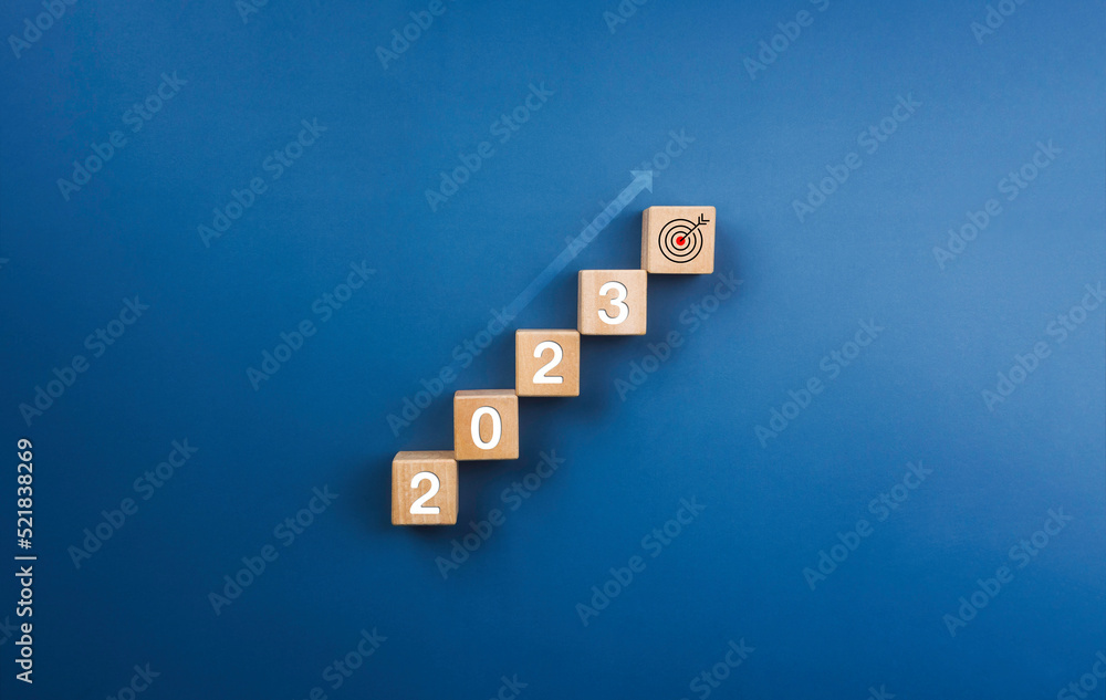 2023 year numbers on on wooden blocks stack, chart steps with shining ...
