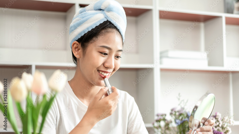 Half Japanese woman putting on makeup and hair to prepare for work in ...