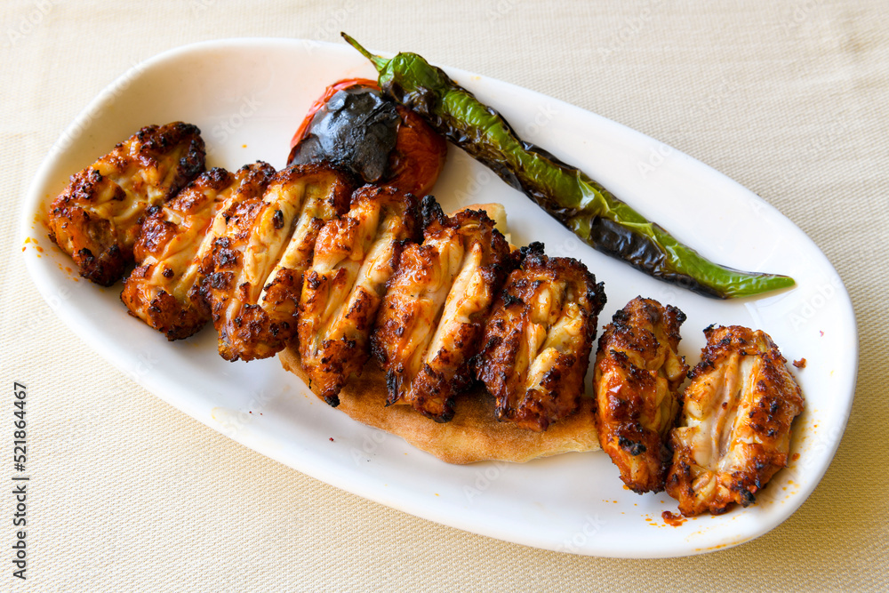 Chicken wings barbeque in a dish with BBQ sauce . Izgara tavuk sis ...