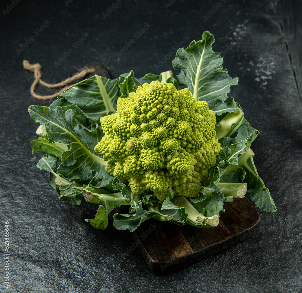 Romanesco broccoli head on a dark stone surface, cabbage, close up ...
