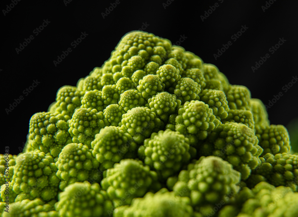 Romanesco broccoli head on a dark stone surface, cabbage, close up ...