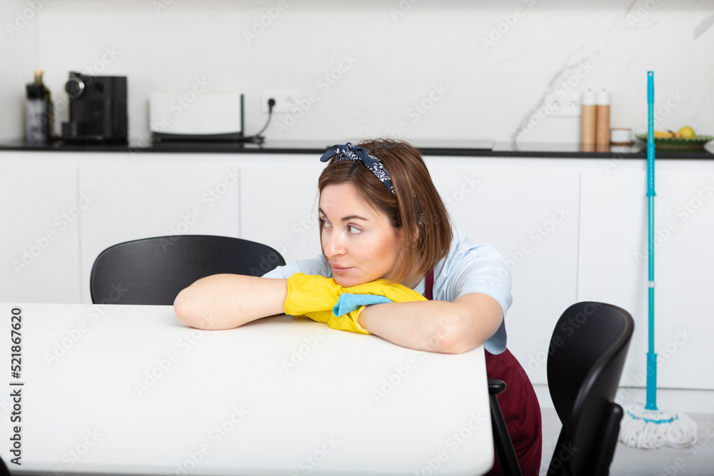 Tired woman fall asleep on white table while wiping cleaning the living ...