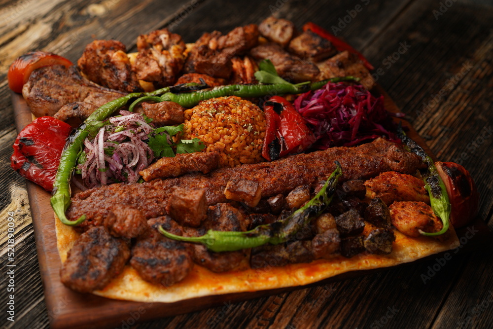 Turkish traditional mixed kebab on wooden plate. Turkish and Arabic ...