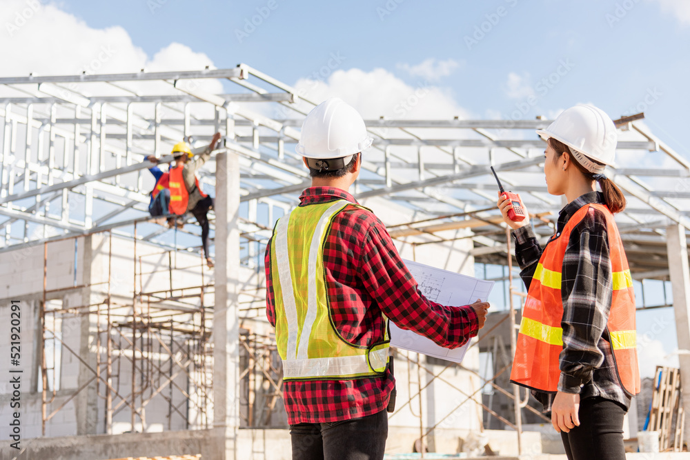 Back two architect and client discussing help create plan with ...