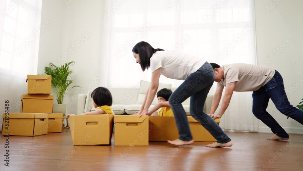 New House, a Happy Asian family with two children playing is pushing ...