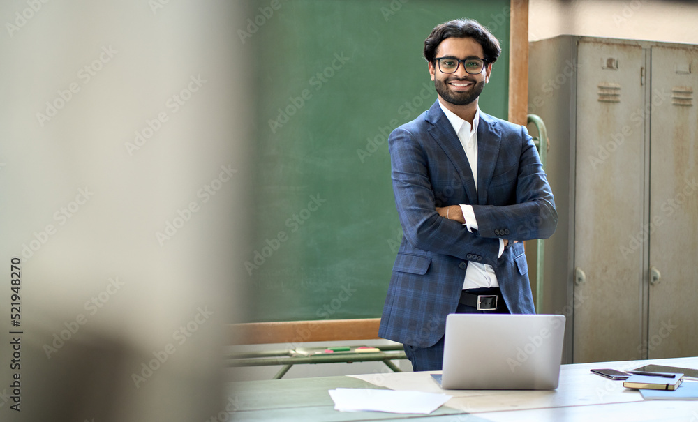 Happy young adult indian business man coach wearing suit looking at ...