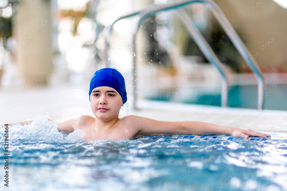 Boy in the swimming pool. Training sessions on the water. Stock Photo ...
