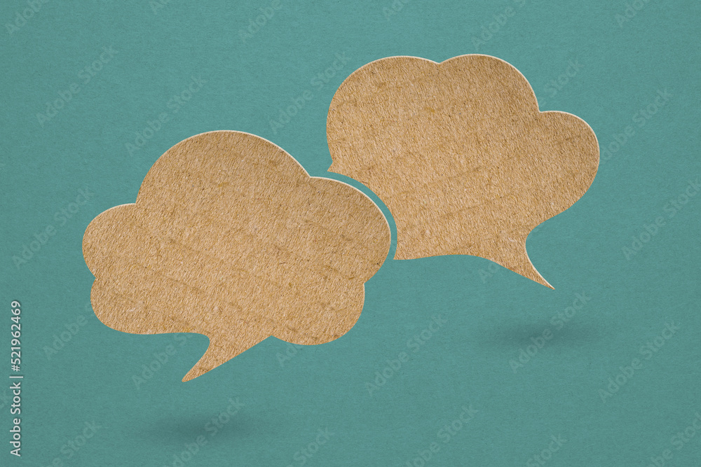 two speech bubbles brown cardboard paper cut, on grunge green ...