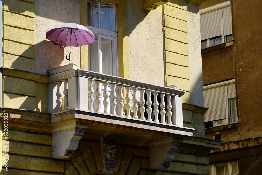 old stone balcony with white balustrade on multi level residential building in Budapest, Hungary ...