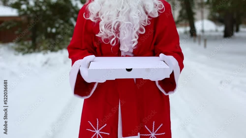 White pizza box open in hands of Santa Claus in white mittens, with ...
