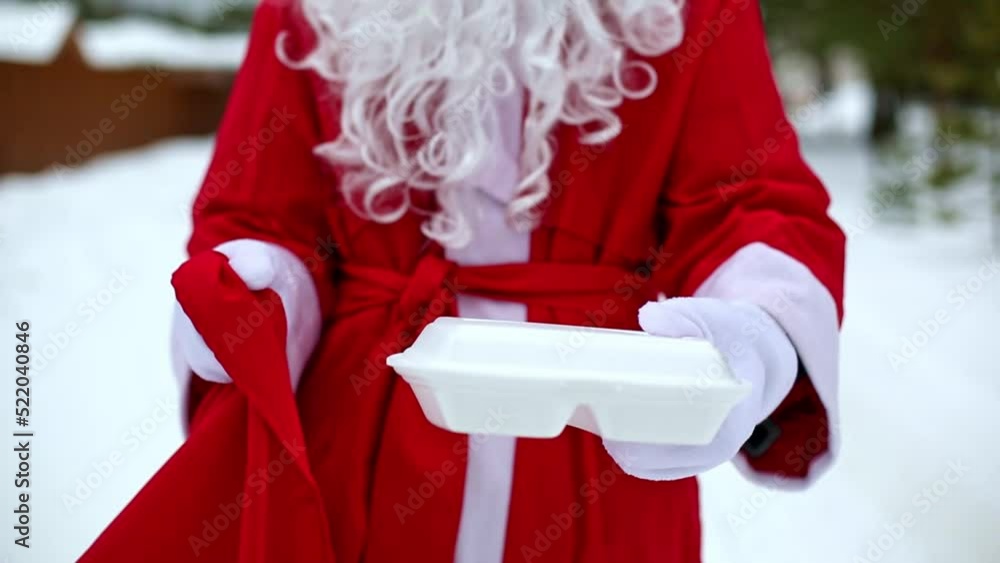 Food delivery service containers in hands of Santa Claus outdoor in ...