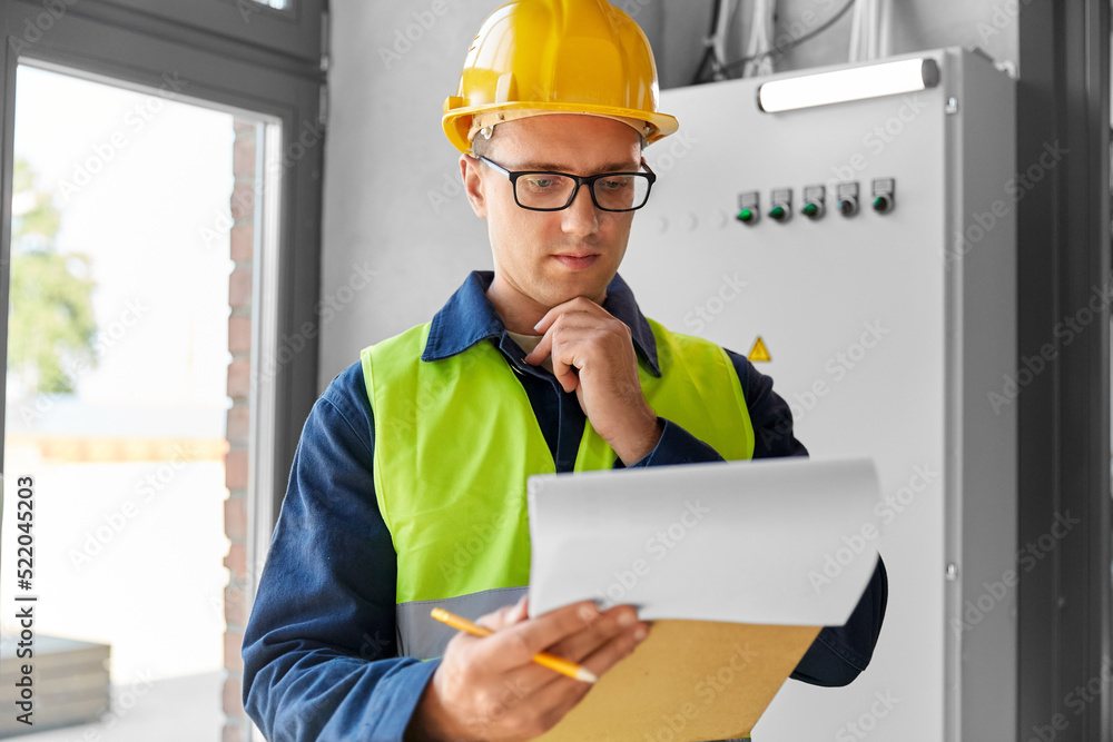 construction business and building concept - male electrician or worker ...