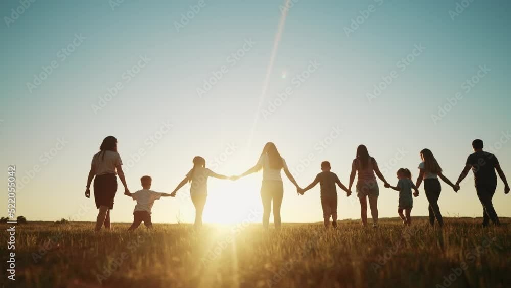community large family in the park. a large group of people holding ...