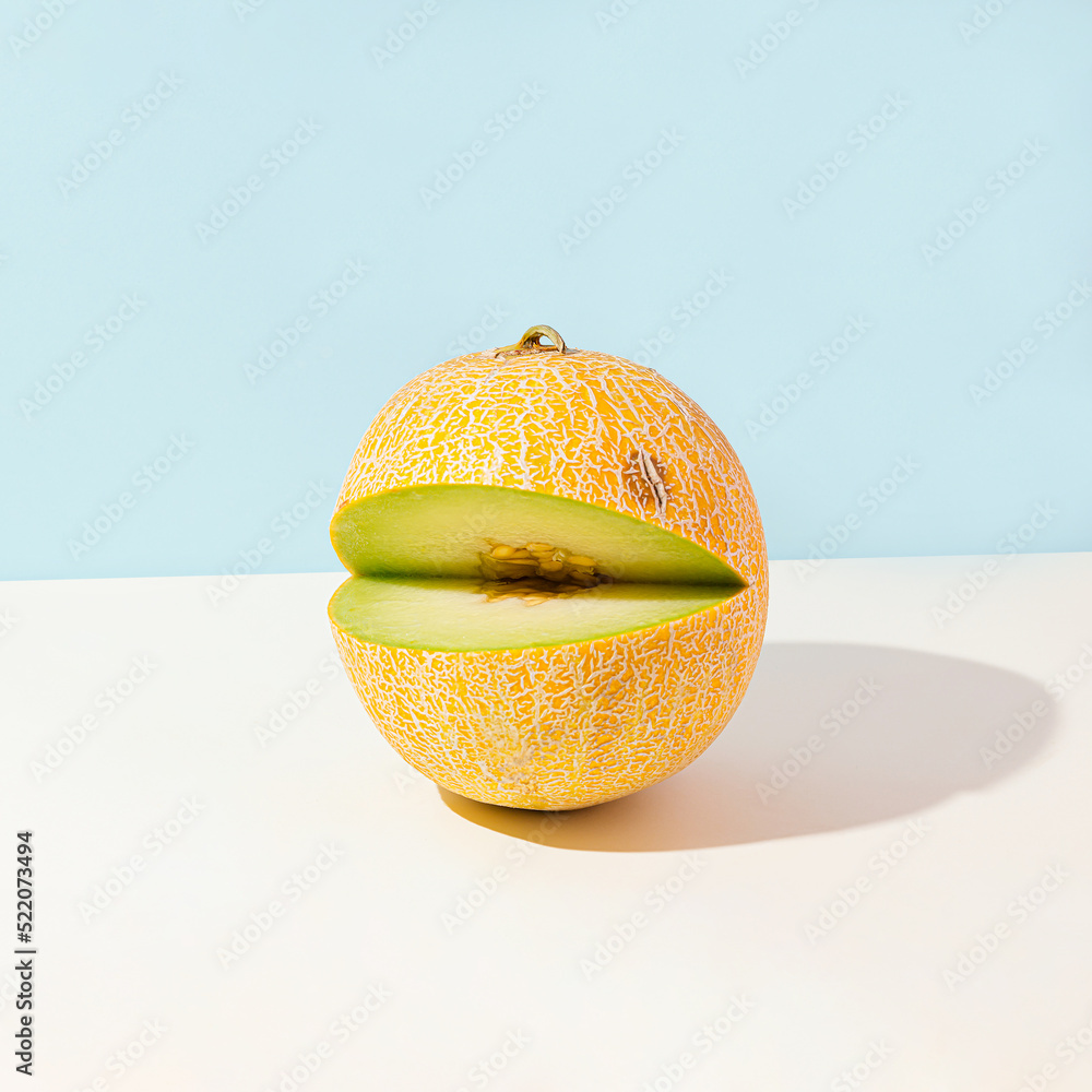 Happy emoticon with smile made of cut melon on isolated pastel blue and ...