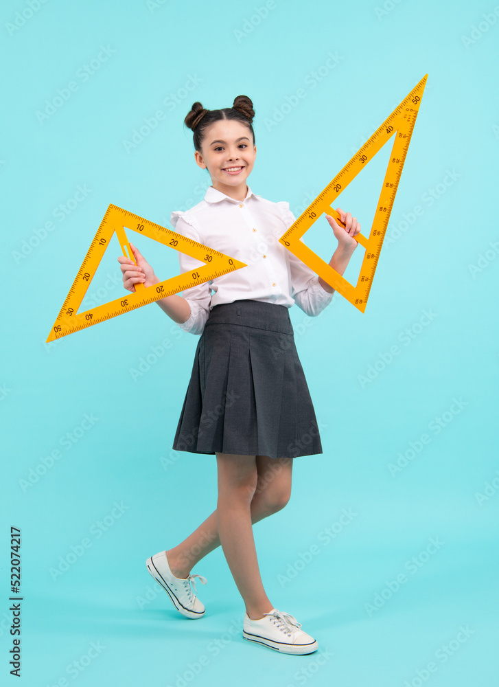 Measuring school equipment. Schoolgirl holding measure for geometry ...