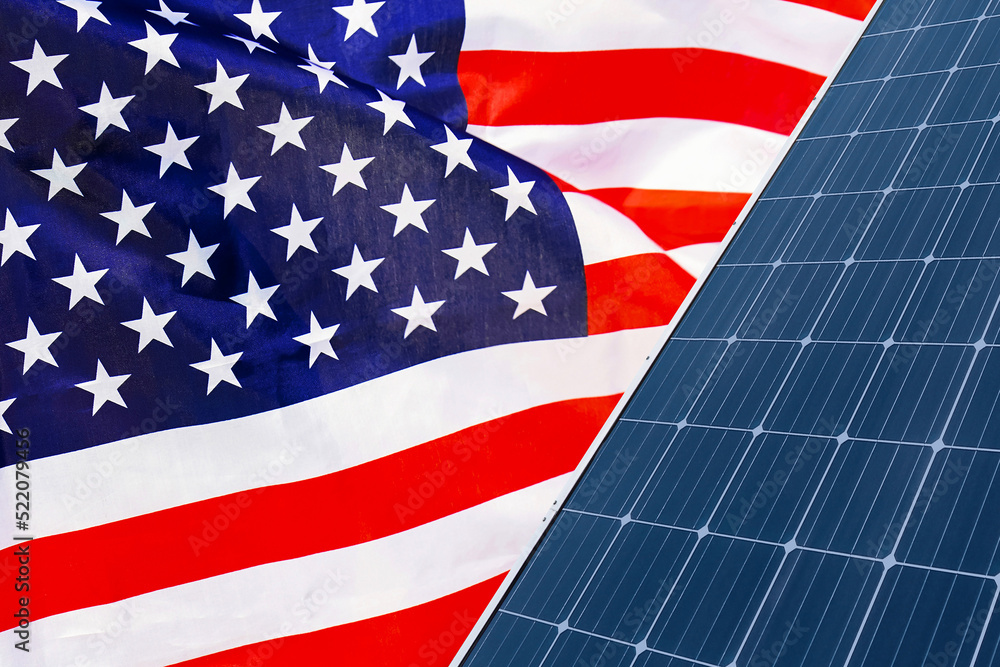 Solar panels against flag US background. Solar battery generates a pure ...
