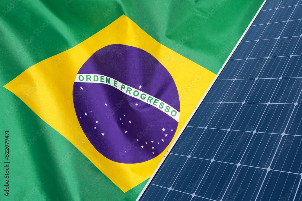 Solar panels against flag Brazil background. Solar battery generates a ...