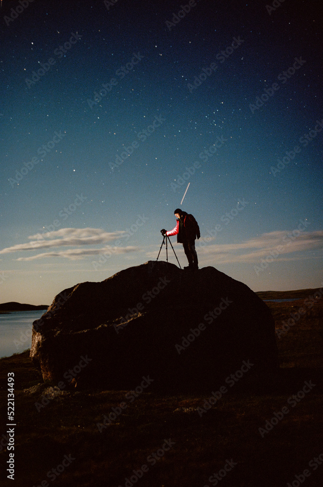 Man is taking photos of night sky with camera on tripod Stock Photo ...