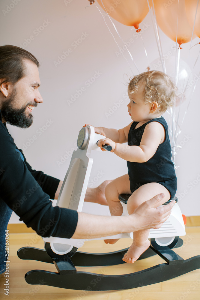 Baby On Rocking Chair With Balloons Stock Photo | Adobe Stock