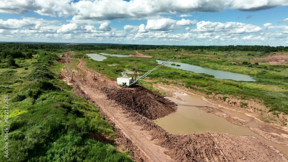 Open-pit mining. Dragline excavator load clay in freight train. Clay ...