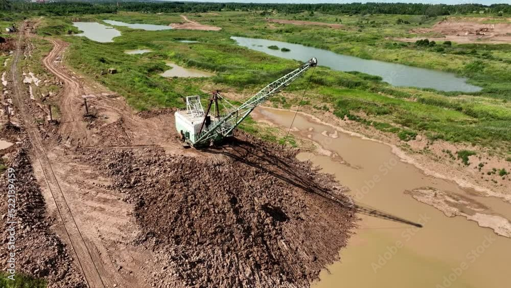 Open-pit mining. Dragline excavator load clay in freight train. Clay ...