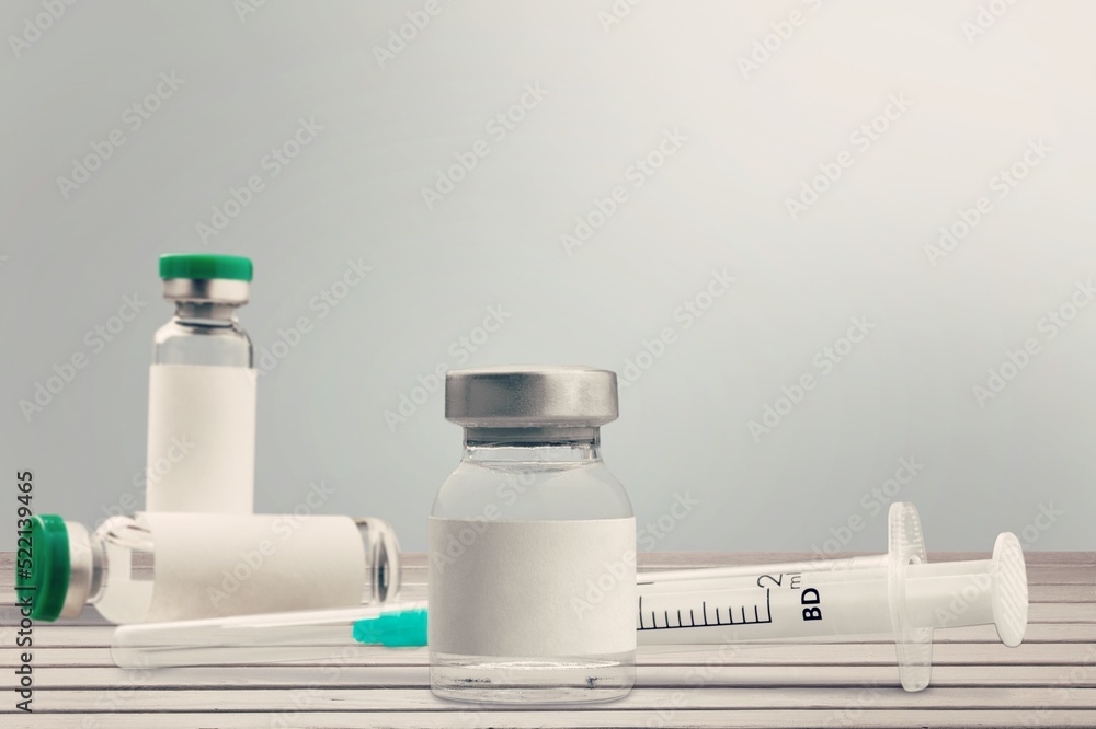 medical liquid for injection in a glass vial on the desk Stock Photo ...