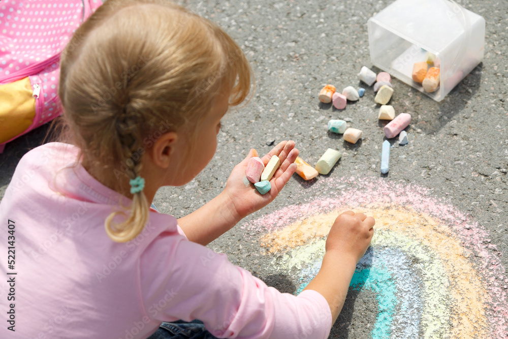 Girl holding chalk and drawing Stock Photo | Adobe Stock