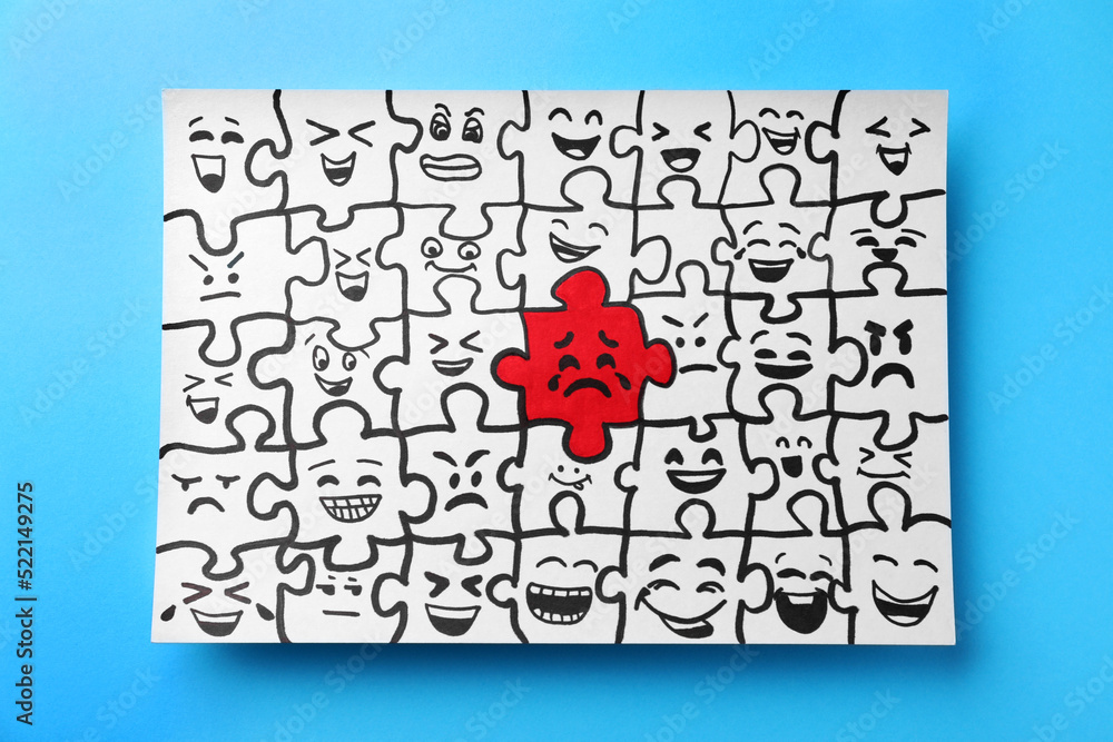 Drawing of white puzzle pieces and one red with different emotions on ...