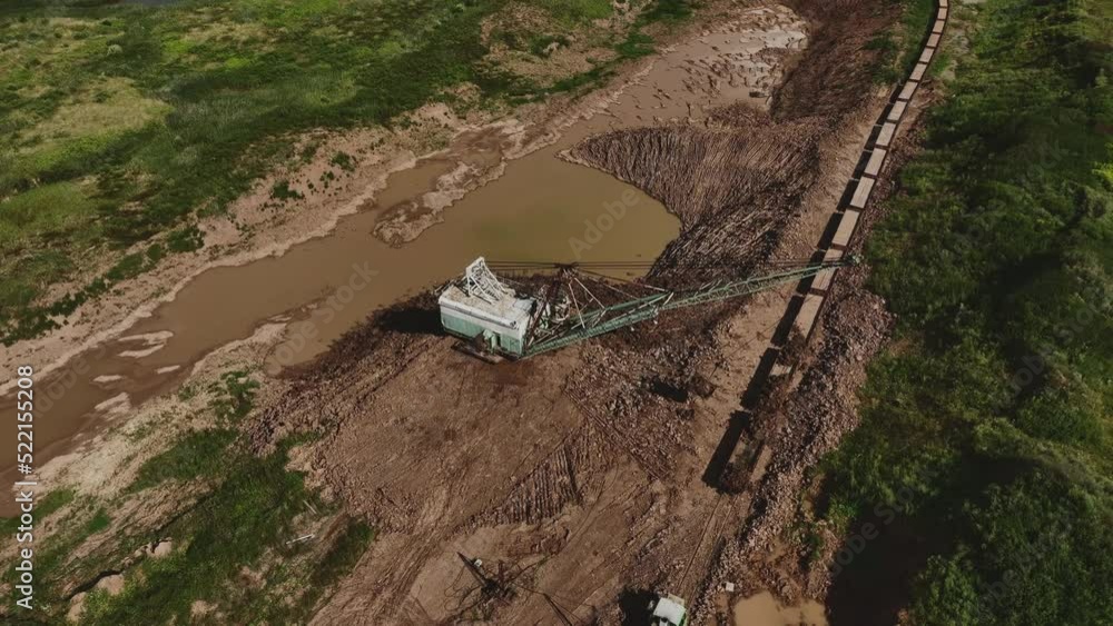 Open-pit mining. Dragline excavator load clay in freight train. Clay ...