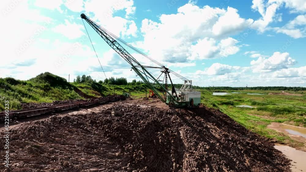 Open-pit mining. Dragline excavator load clay in freight train. Clay ...