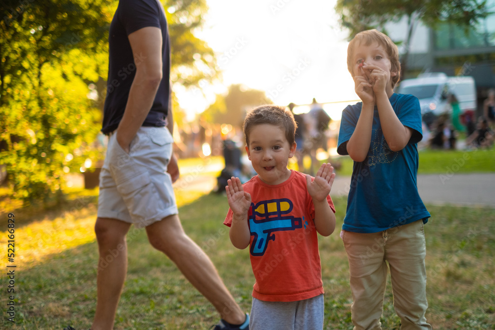 Looking at camera, goofy portraits of kids playing outside in the park ...