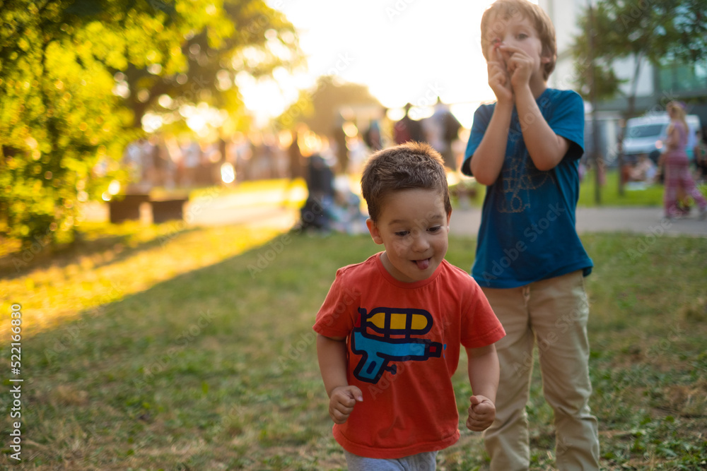 Looking at camera, goofy portraits of kids playing outside in the park ...