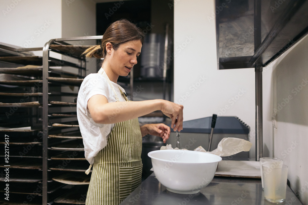 Pastry chef working in the kitchen of her business Stock Photo | Adobe ...