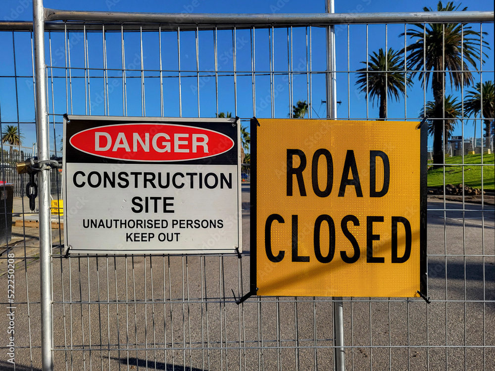 Construction site warning signs in yellow informing of road closure ...