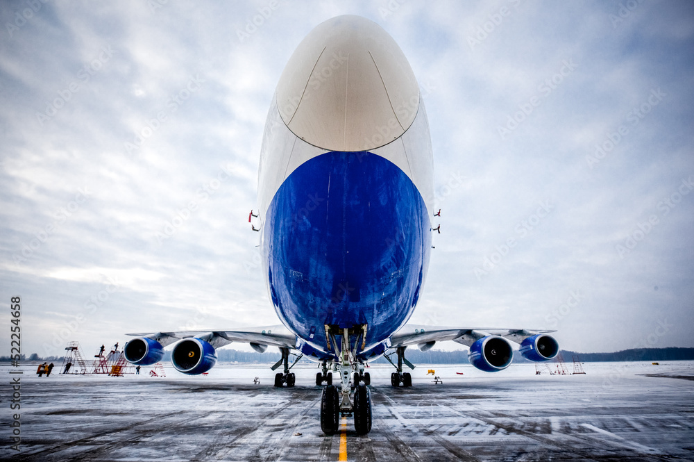 Airplane front fuselage with blue sky. Aircraft on runway of airfield ...