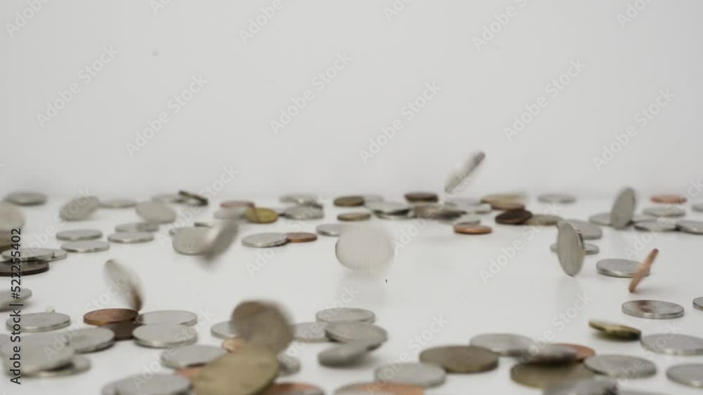 Falling coins in slow motion. Many coins of different values fall in ...