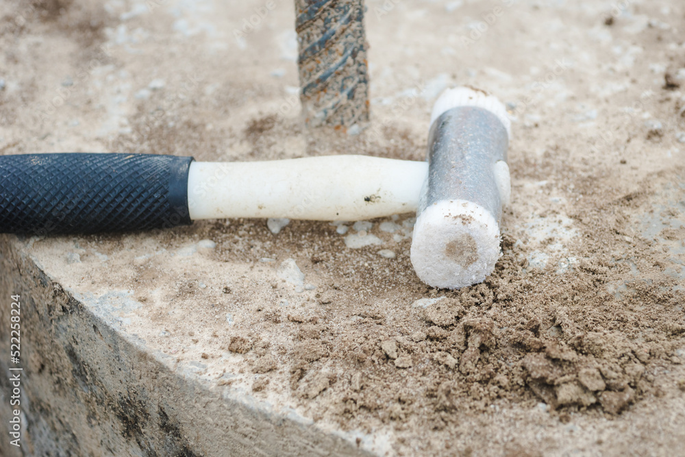 Seismic test on concrete pile. Engineer using the PIT Hand-Held Hammer ...