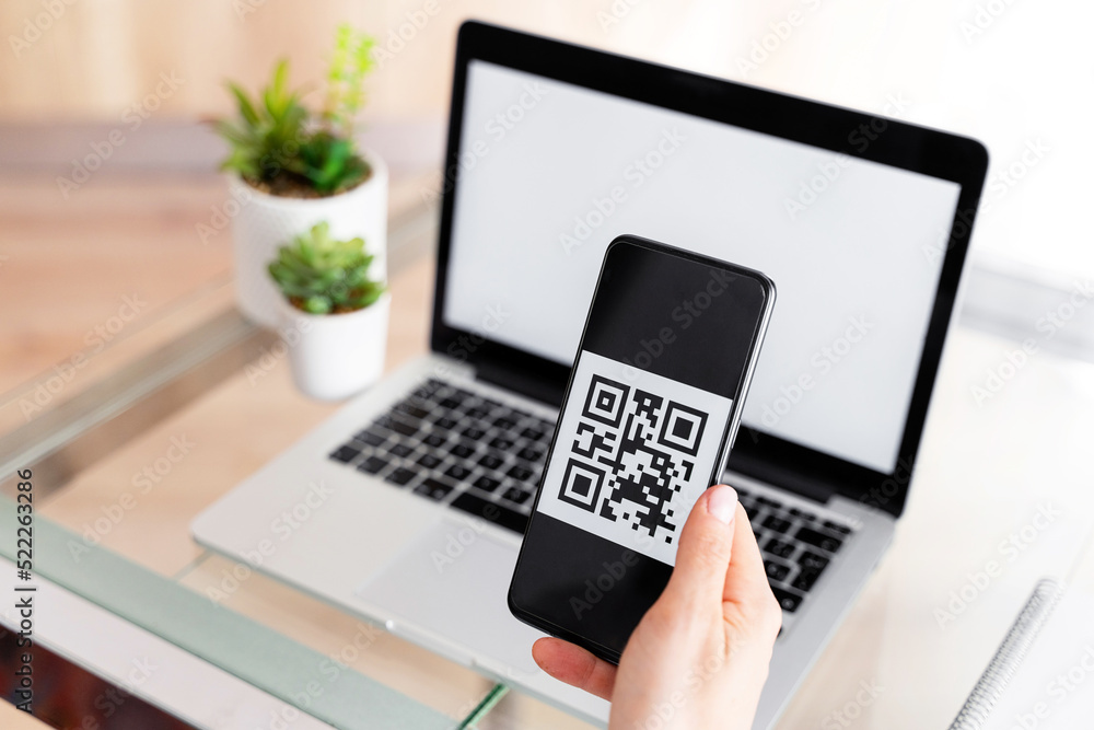 Faceless woman scanning QR code with smartphone Stock Photo | Adobe Stock
