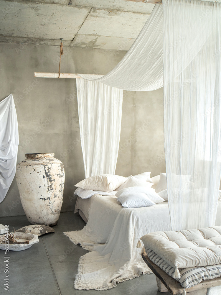 Natural style bedroom interior with a big bed, white linen and pillows ...