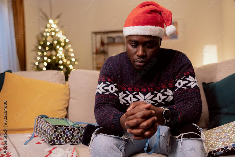Sad disappointed man spends alone Christmas Eve, Day, wearing a Santa ...
