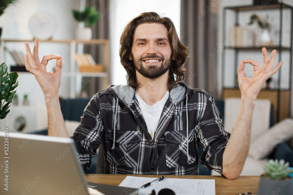 Relaxed caucasian man in casual wear sitting on workplace with modern ...
