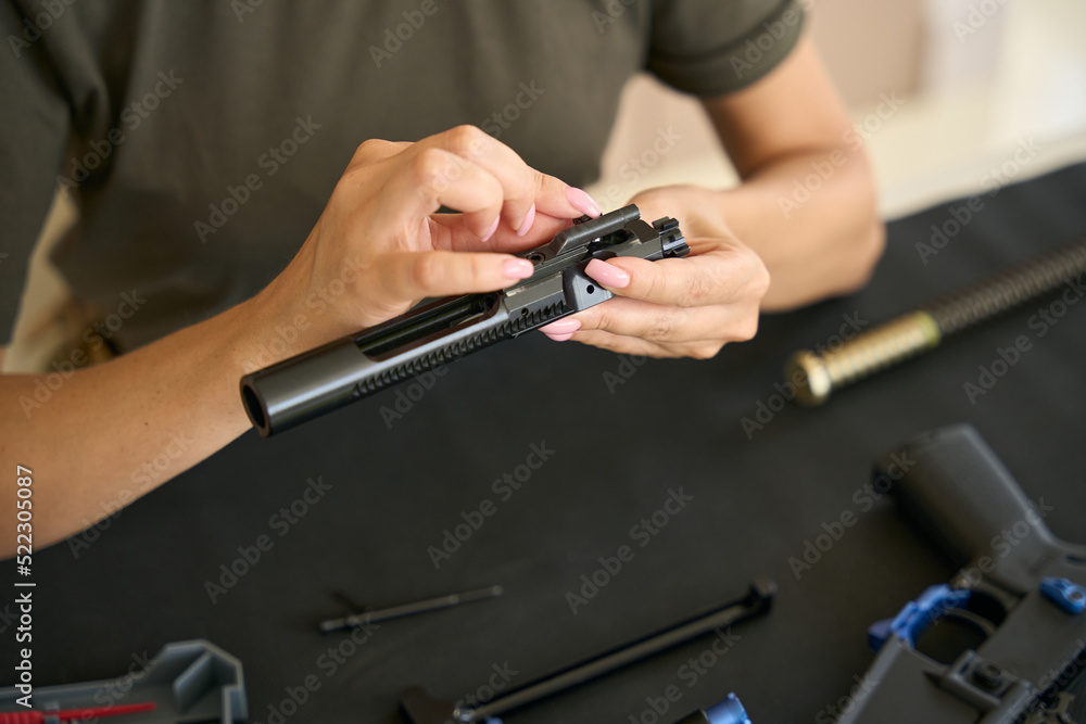 Military woman is caring for disassembled firearms Stock Photo | Adobe ...